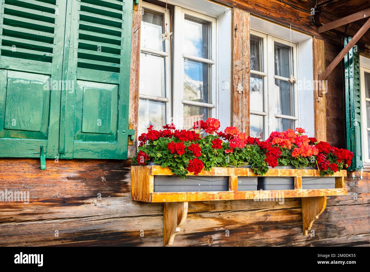 Flowers in rustic balcony at springtime with window, Interlaken, Switzerland Stock Photo - Alamy