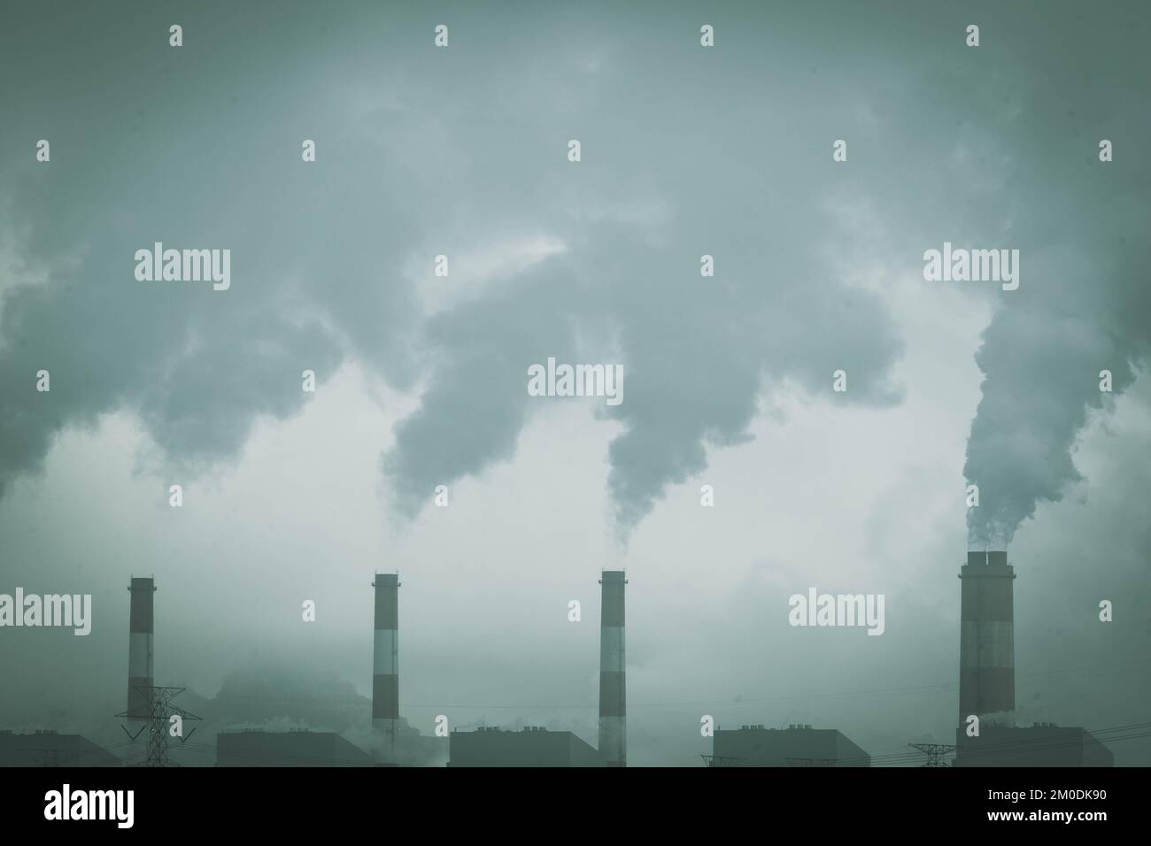 Cropped shot of coal power plant with steam pouring out of the stack ...