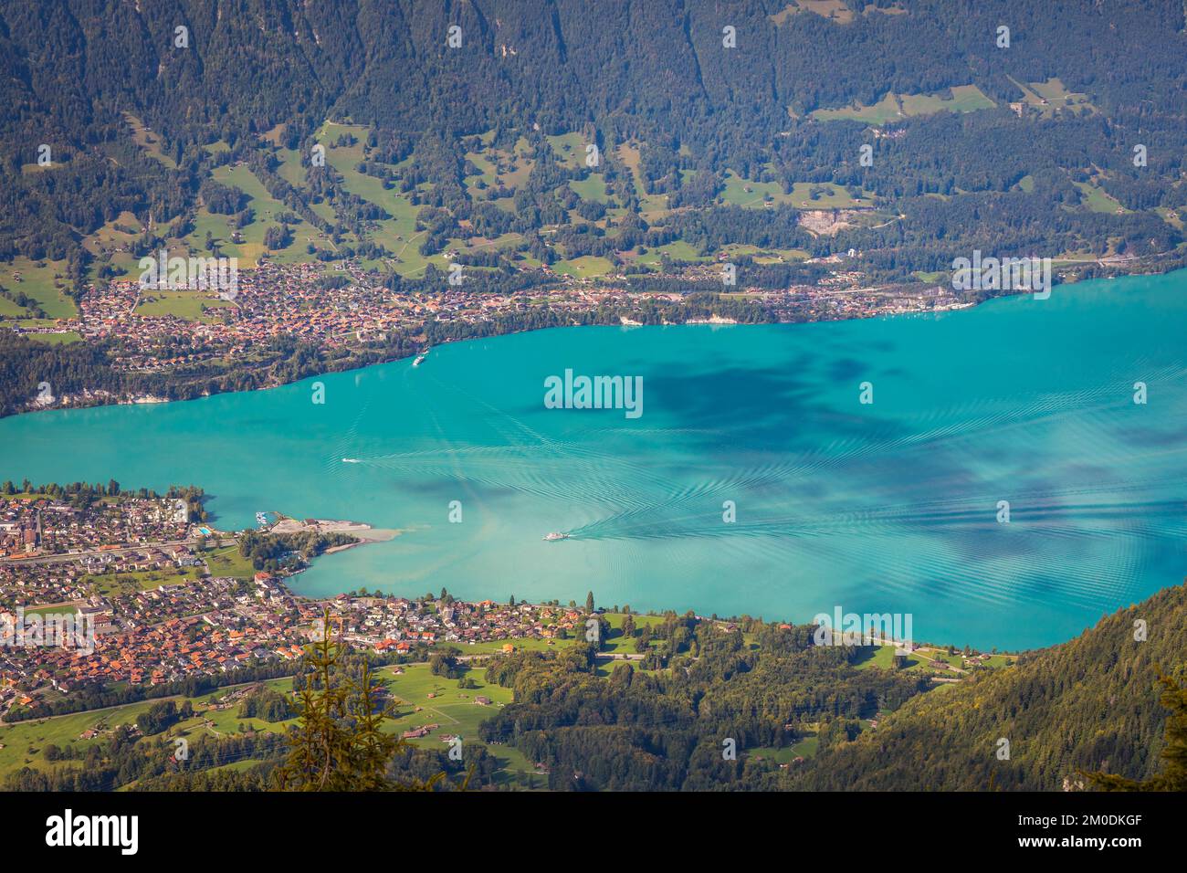 Aerial view of Swiss Alps and Lake Brienz with ferry boat at sunset ...
