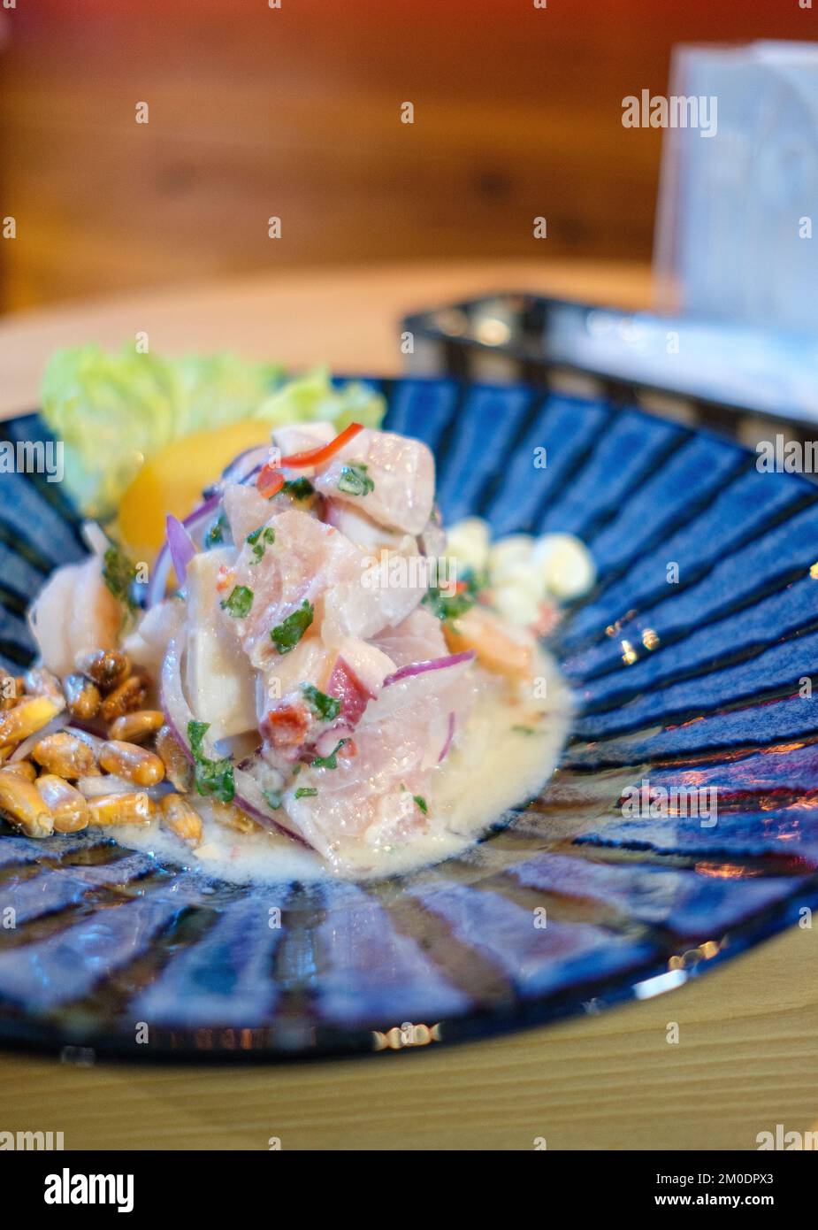 Peruvian ceviche served on a blue plat Stock Photo - Alamy