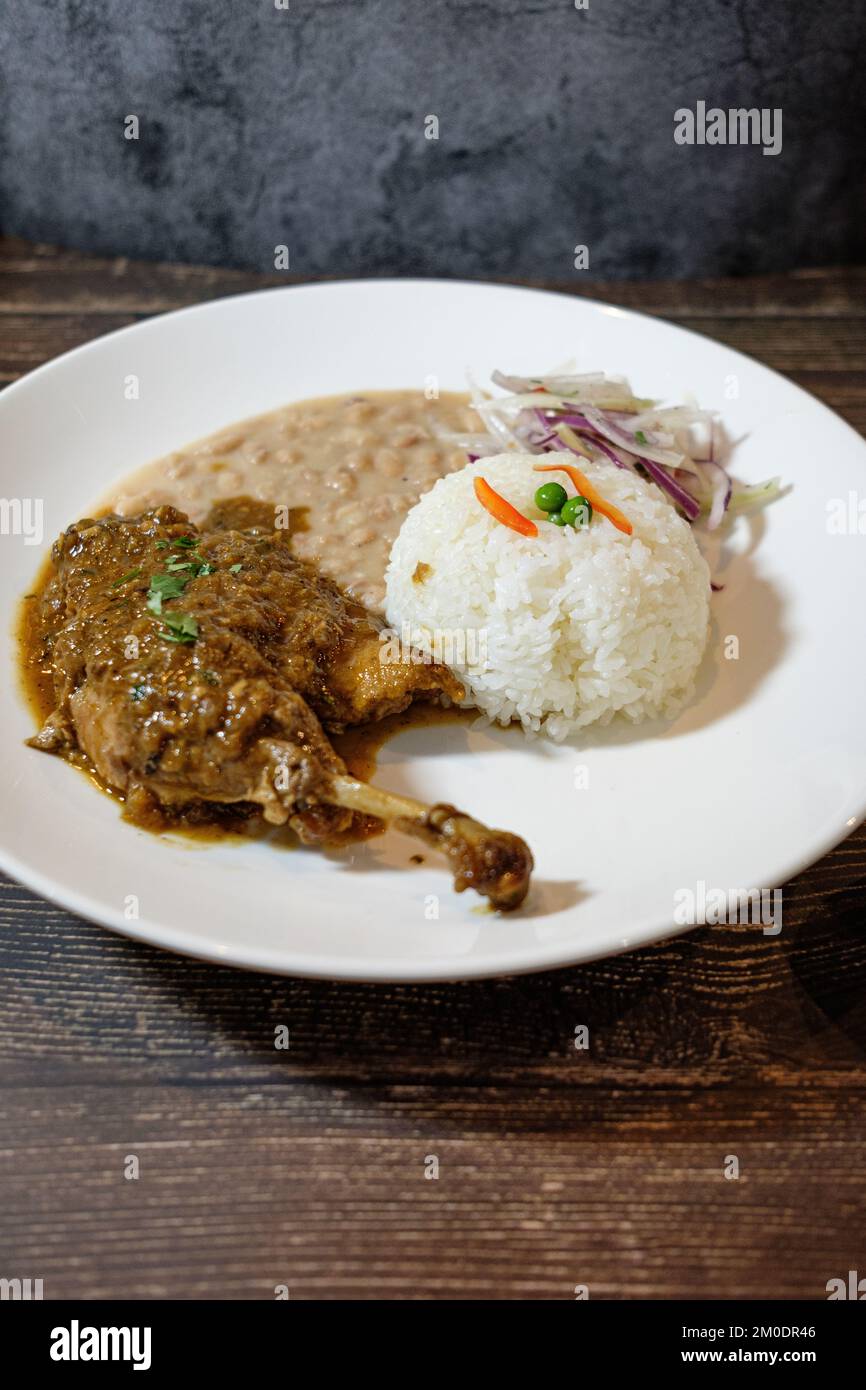 white beans with chicken and beef, served with rice and red onion ...