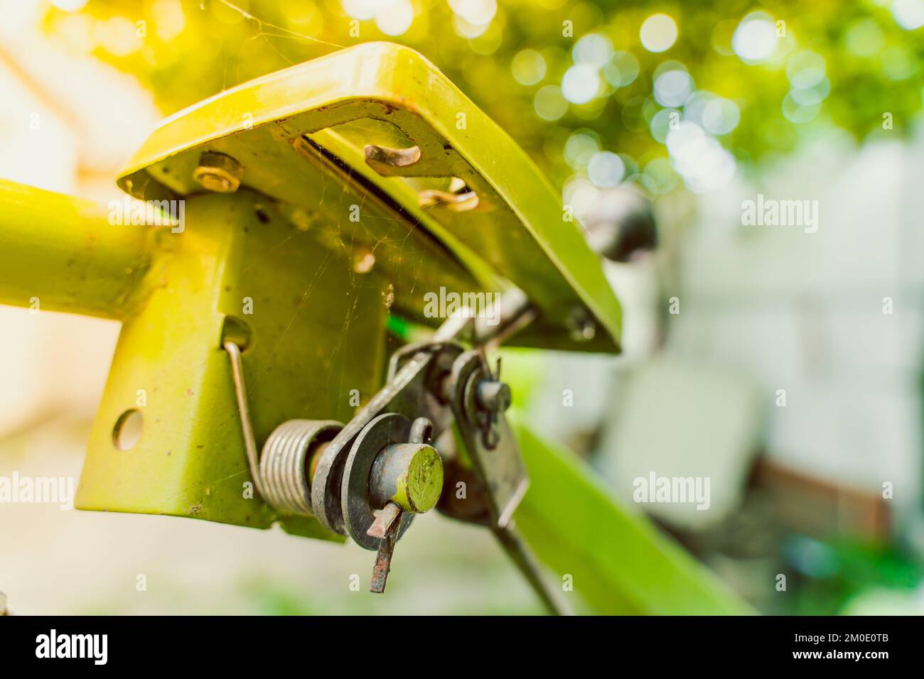 The control lever on a walk-behind tractor close-up on a blurred ...