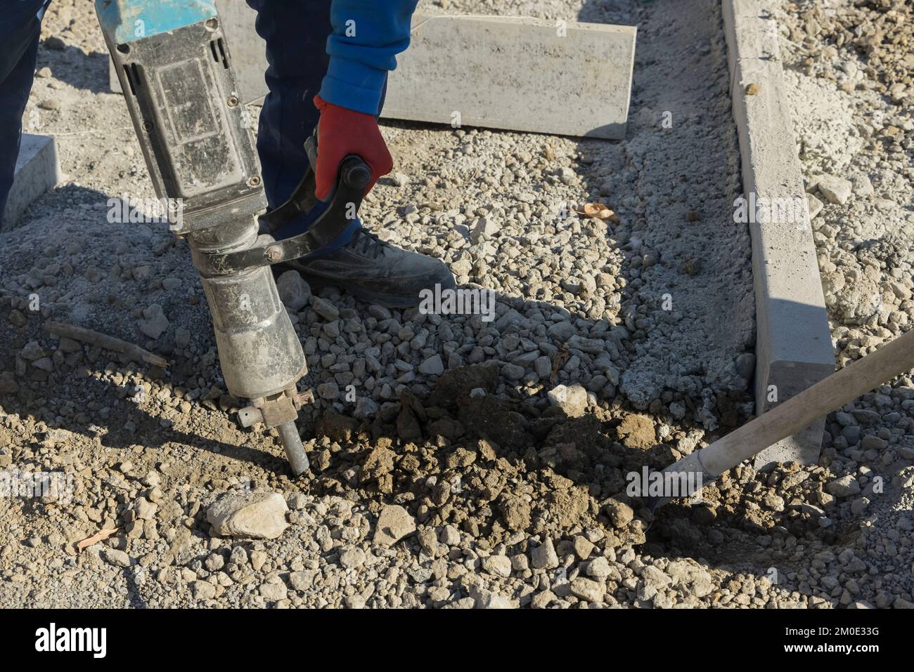 Workers digging and drilling concrete surface of construction road ...