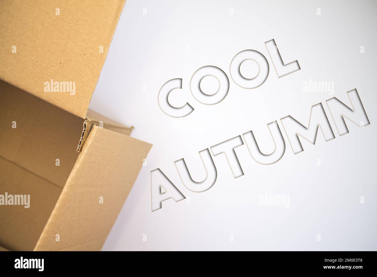 Cool Autumn word with cardboard box. Brown folded card box Stock Photo ...