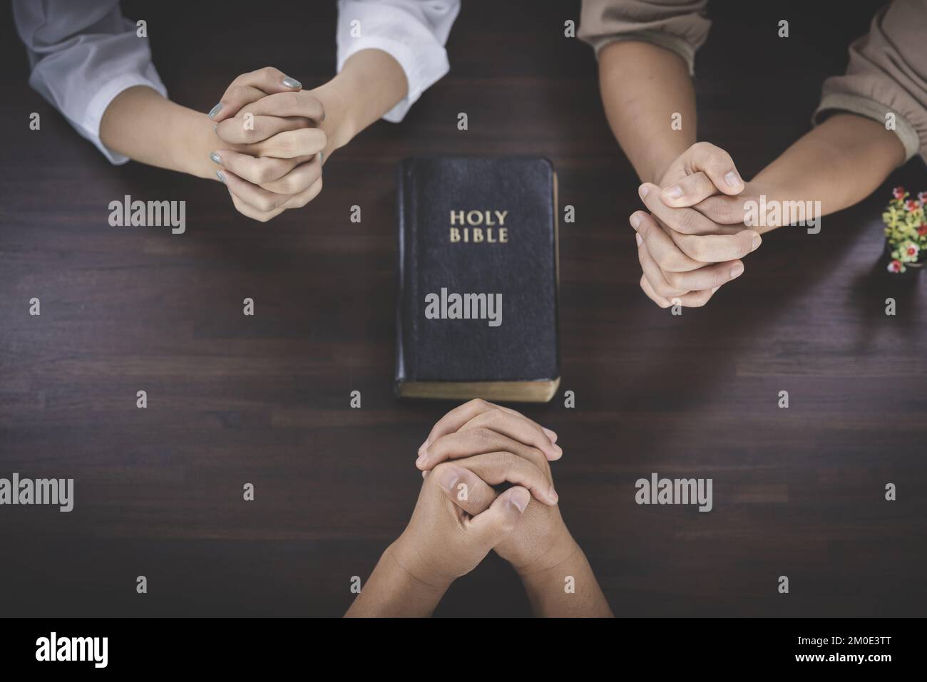 group of women praying together close to the bible Christian bible ...