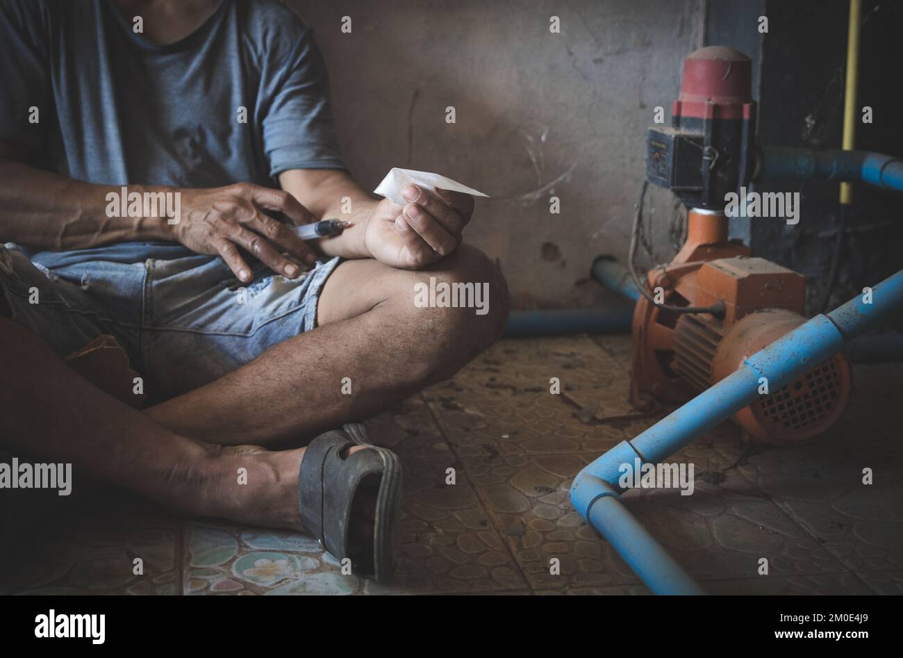 Drug addict holding a syringe about to inject intravenously.Anti-drug ...