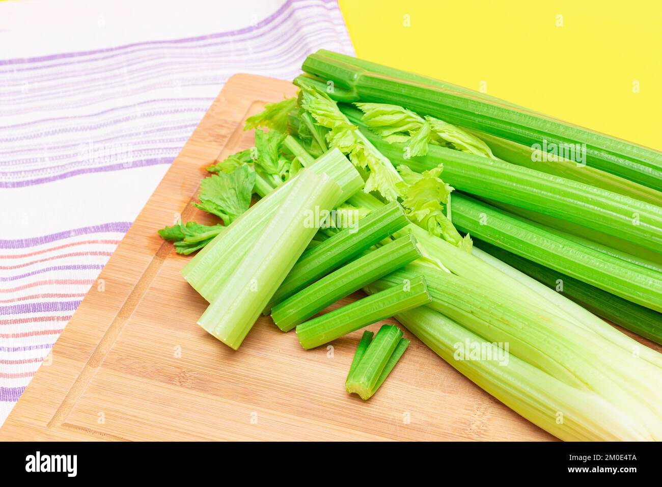 Fresh Celery Stem and Chopped Celery Sticks on Wooden Cutting Board ...