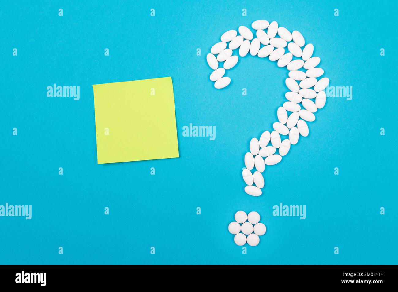 Question Mark Made from White Pills and Tablets with Small Blank Memo ...