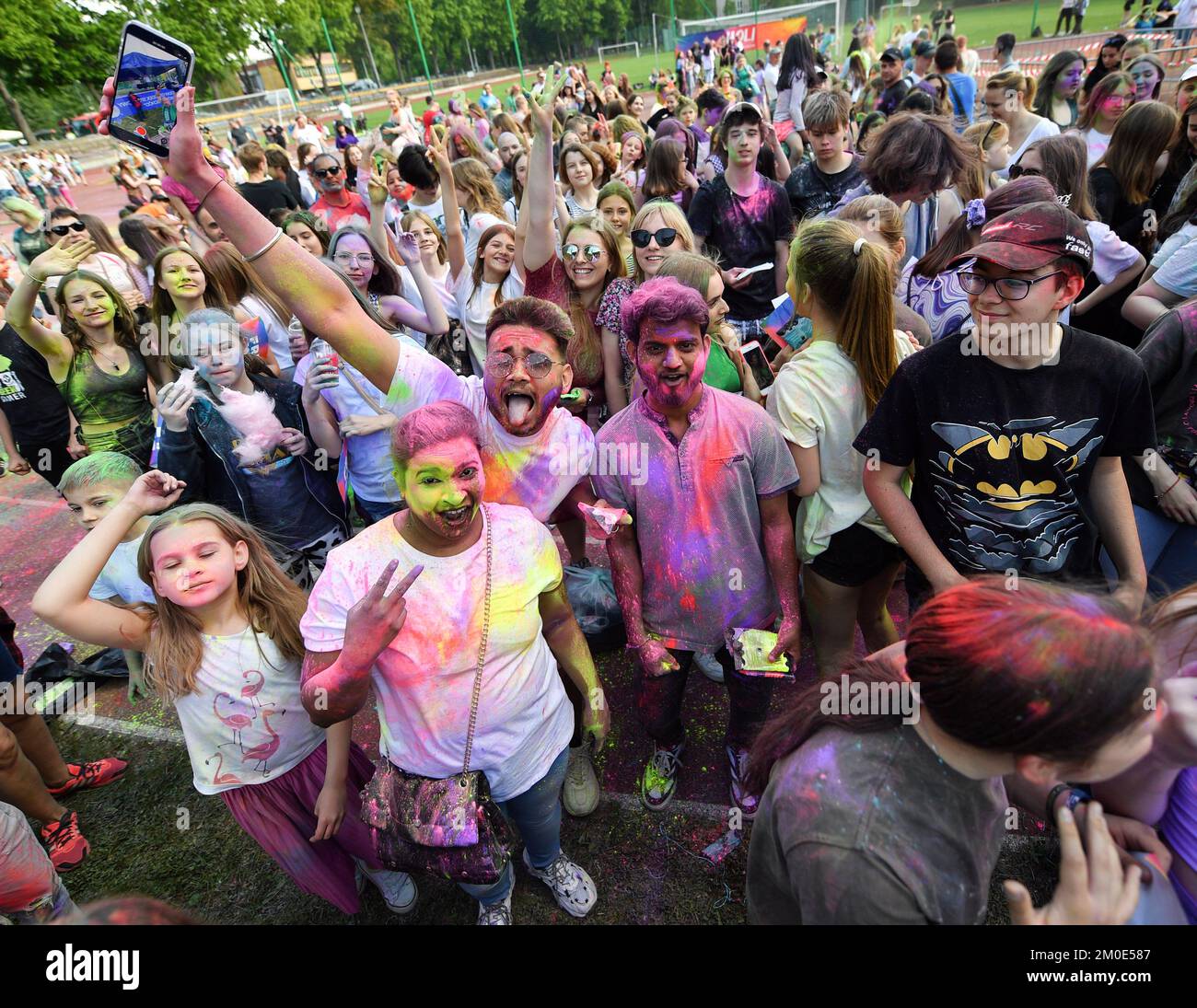 People sprinkled with colorful powders seen having fun during the Holi ...