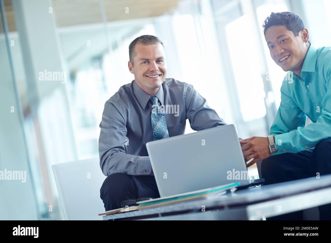 Theyre a dynamic corporate team. Two handsome young businessmen working ...