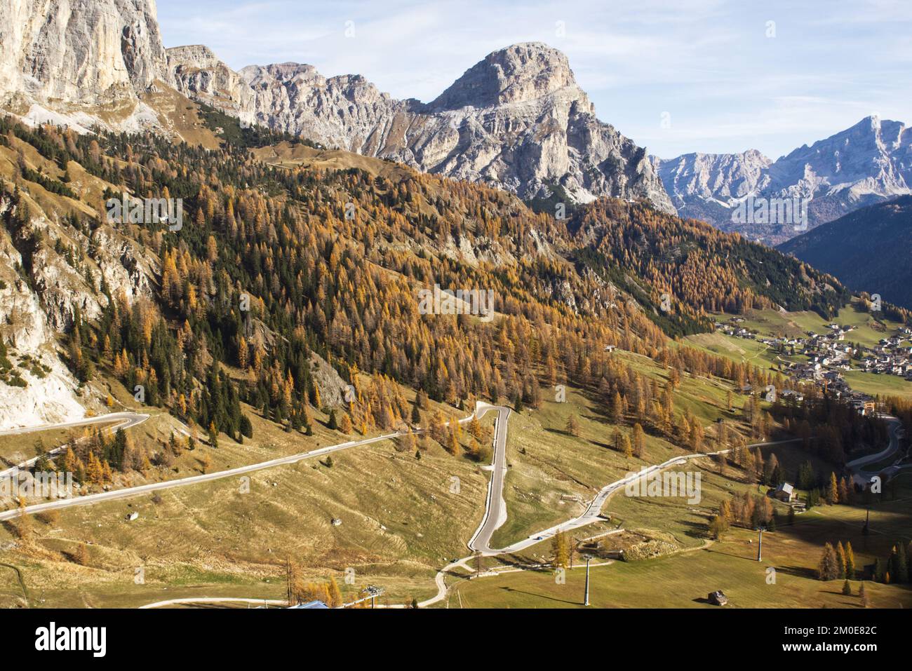 Serpentine narrow asphalt road leading to a village, sunny autumn day ...