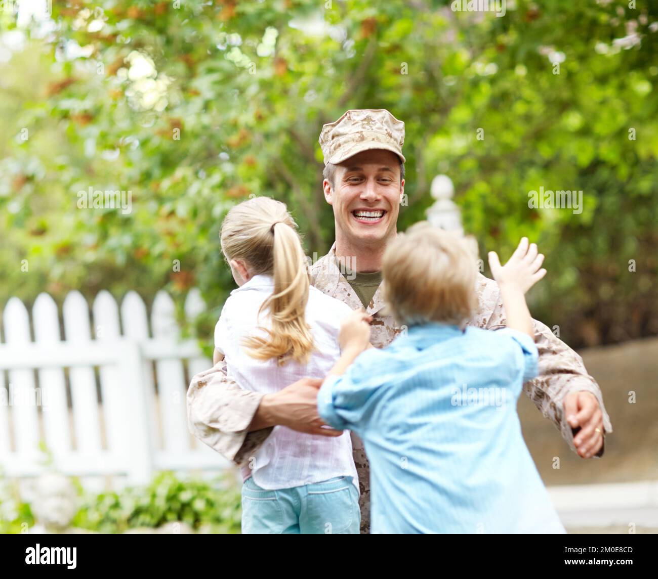 Were so glad youre back. A returning soldier being welcomed by his two ...
