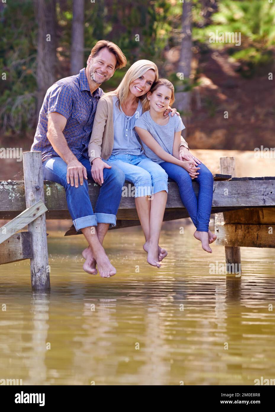 Making family memories. A happy family of three sitting together on the ...