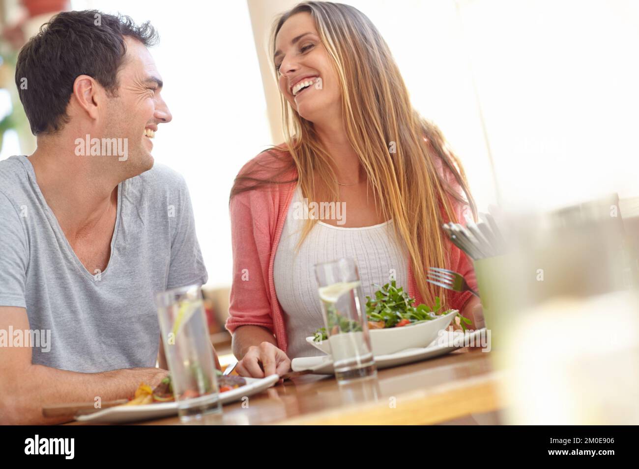 Enjoying a delicious lunch together. A happy young couple enjoying a ...