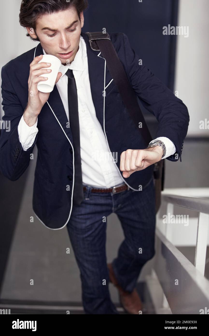 Almost on time. A young man realising hes late while walking up the ...