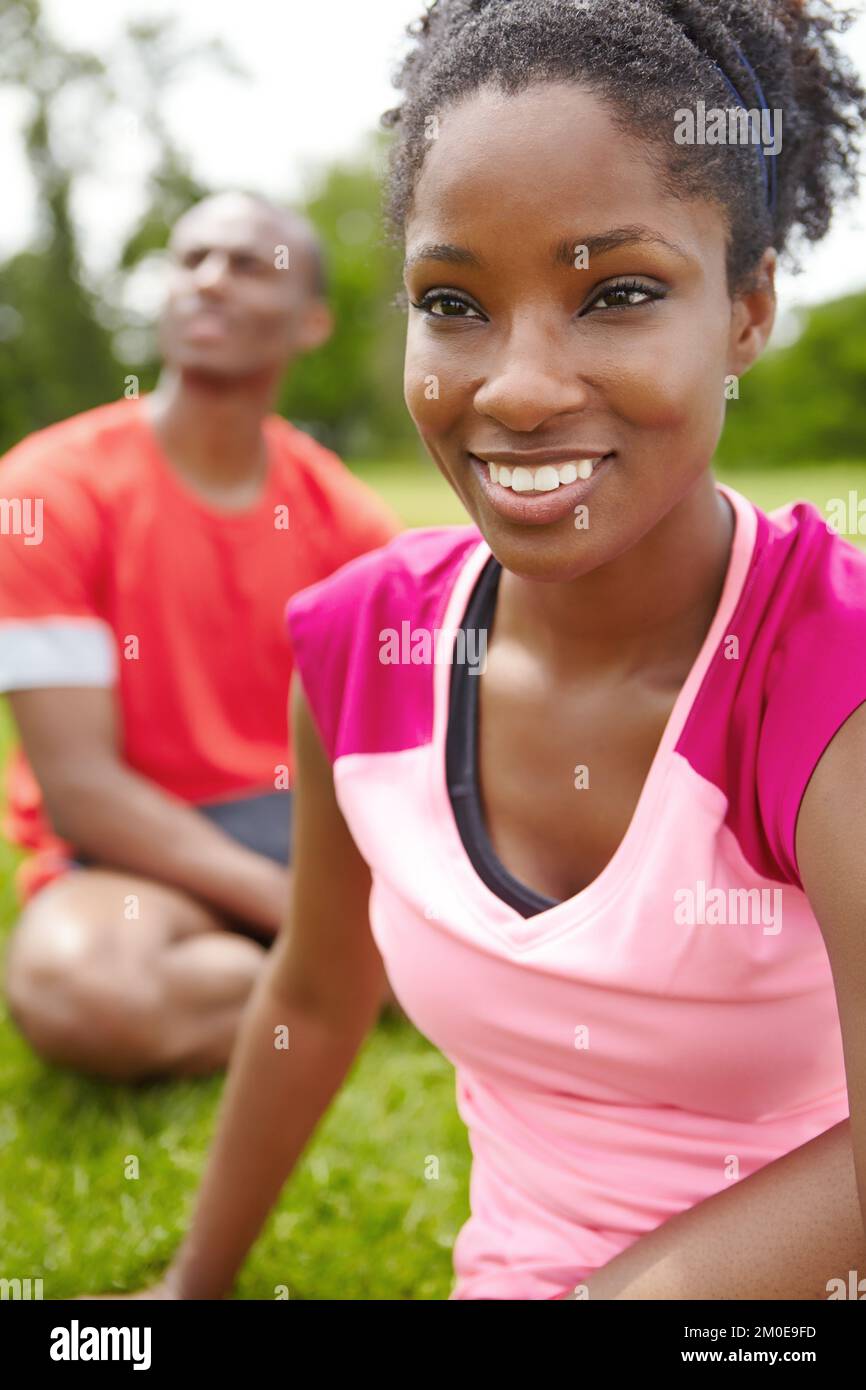 Cooling down outside. Cropped close up of a female athlete sitting on ...