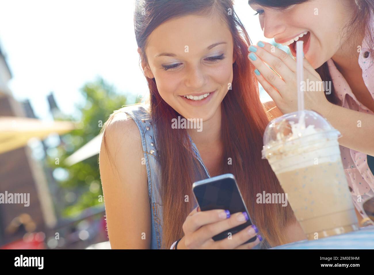 When gossip goes viral...A teenage girl texting on a cellphone while ...