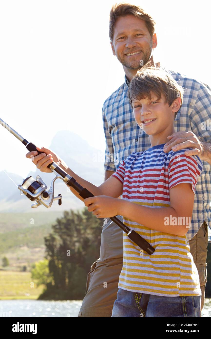 I couldntbe more proud. a father and son holding a fishing rod Stock ...