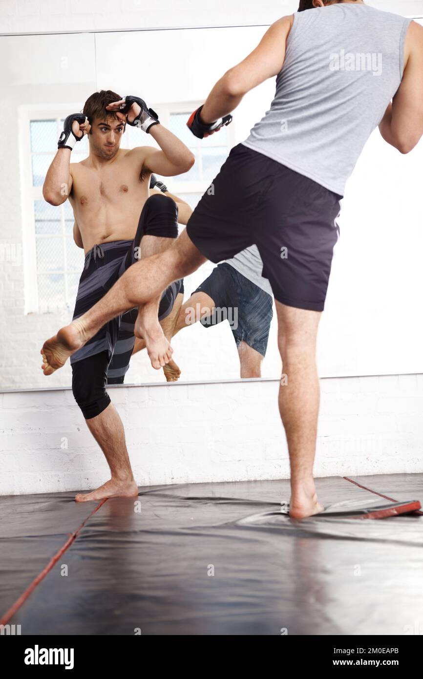 Fast reflexes. Full length shot of two martial artists sparring in the ...