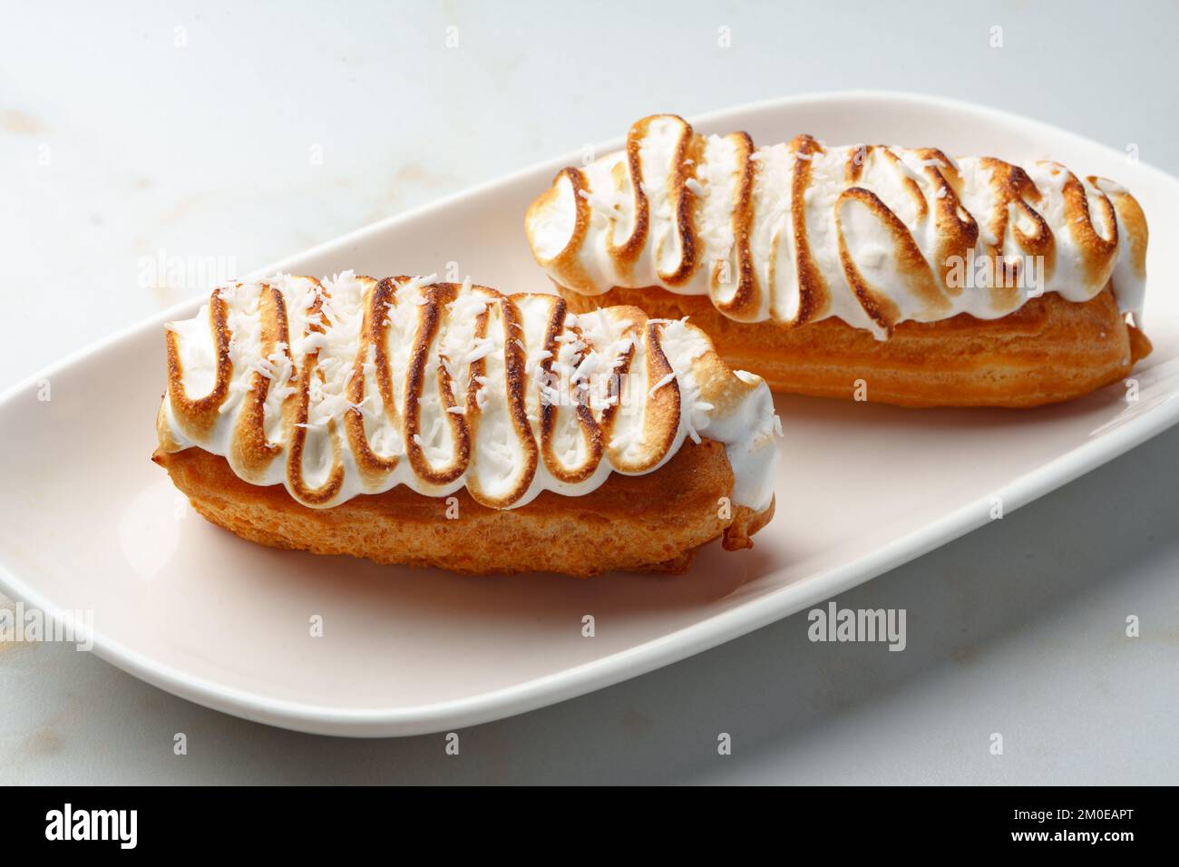 Eclairs with cream decorating of Swiss meringue frosting Stock Photo ...