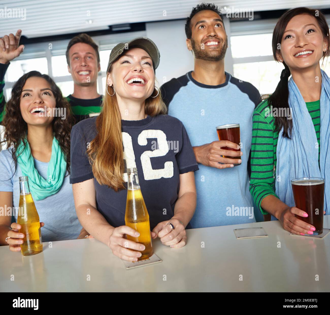 Football with mates. A group of friends cheering on their favourite ...