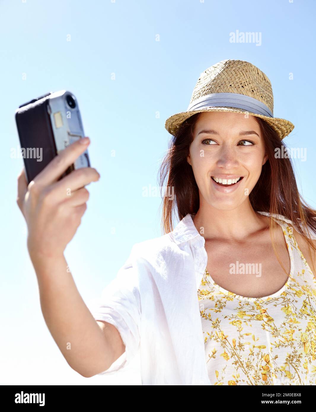 Time for a new profile pic. A lovely young woman taking a self-portrait ...