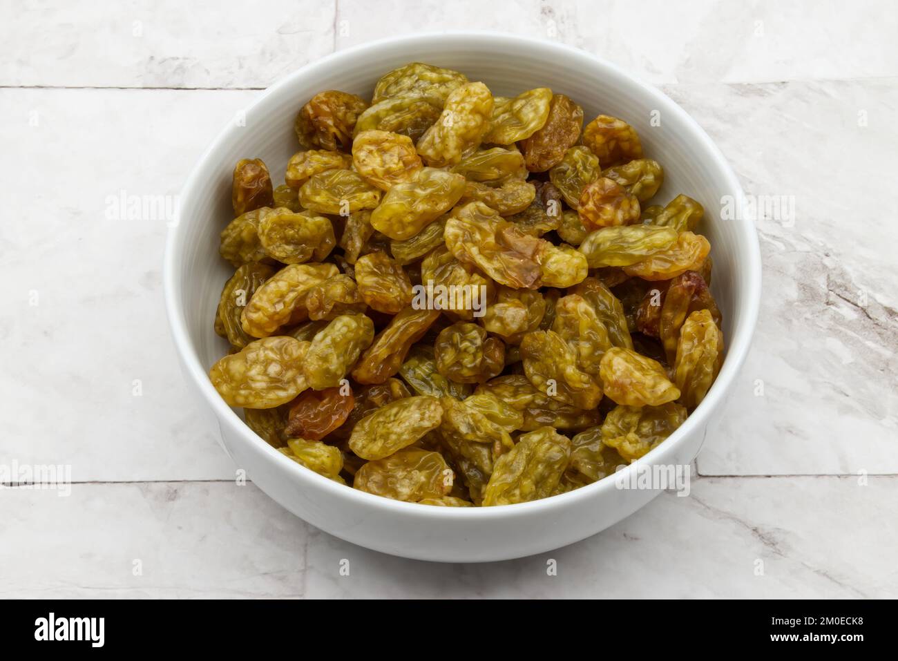 Dried Raisins in a bowl isolated on clear background. Diet food concept ...
