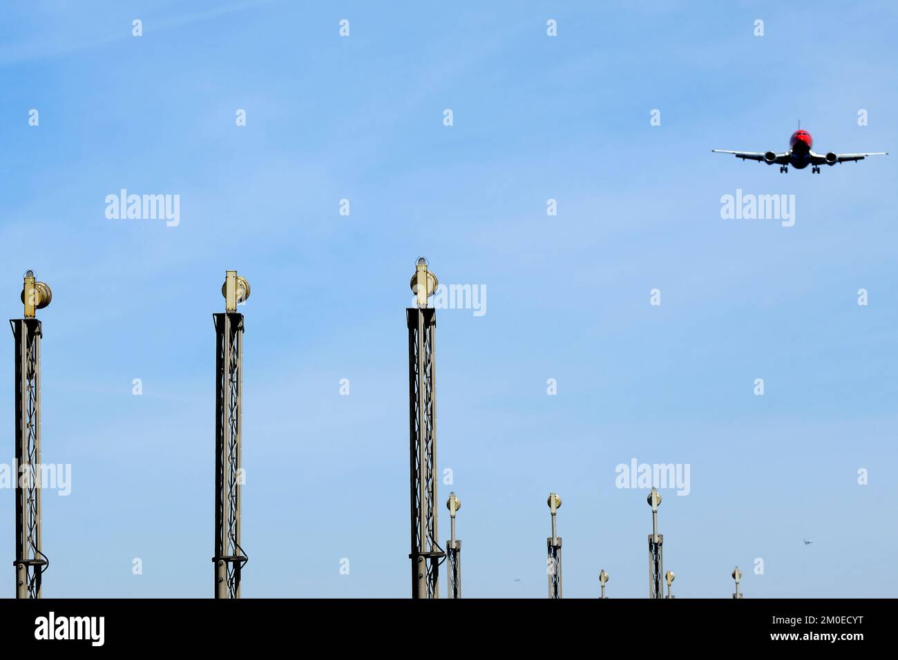 Plane is fllying over lights in airport Stock Photo - Alamy