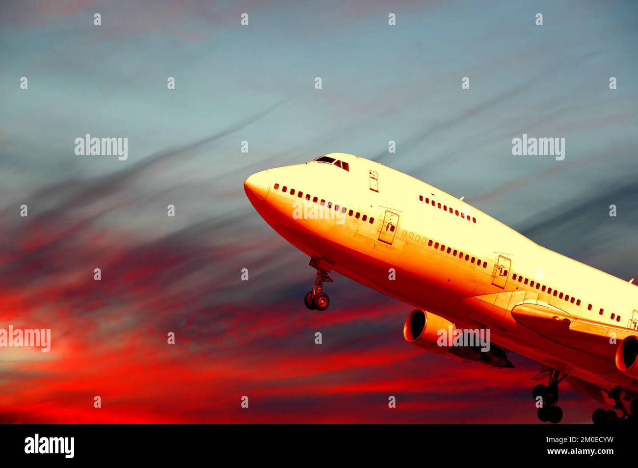 Plane is flying while the sun is setting Stock Photo - Alamy