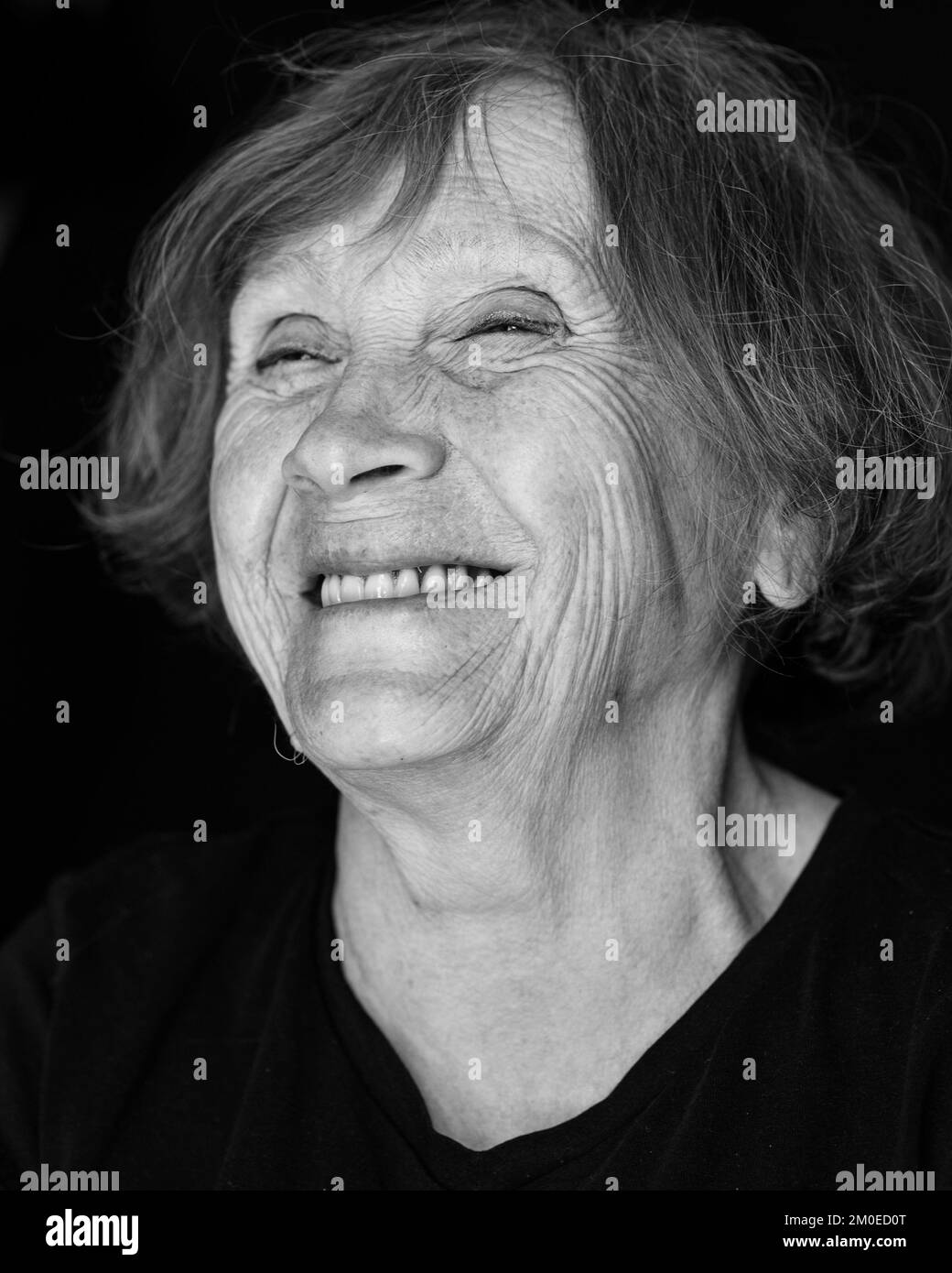 Portrait of senior smiling caucasian woman on black background Stock ...