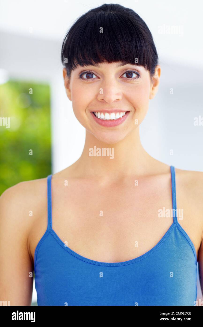 Fresh-faced with a bright smile. Cute young woman in exercise clothing ...