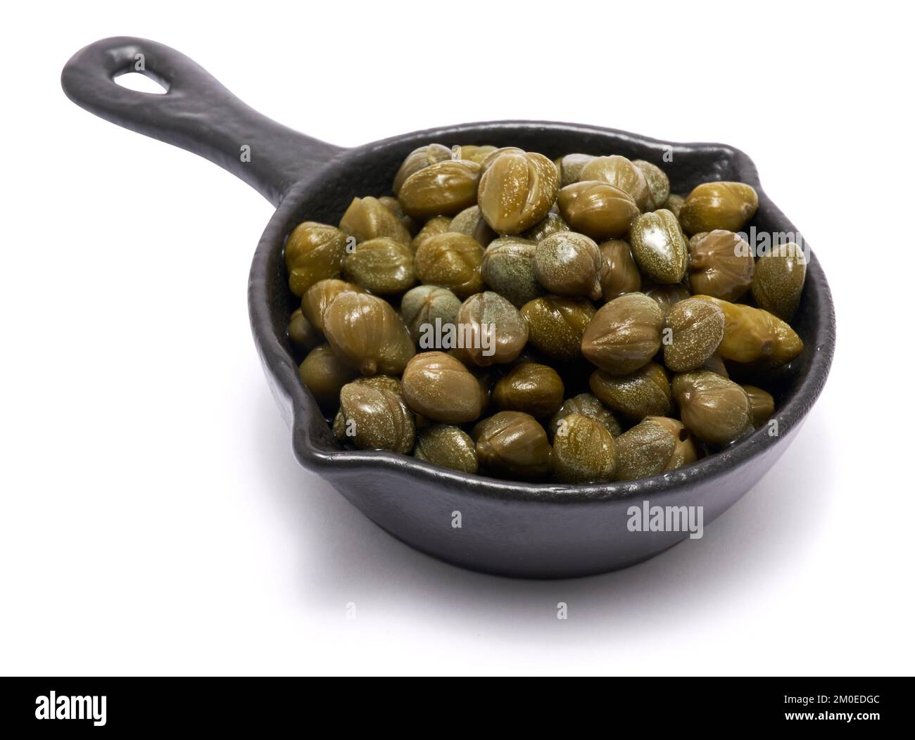 Pickled capers in black ceramic bowl isolated on white background Stock ...