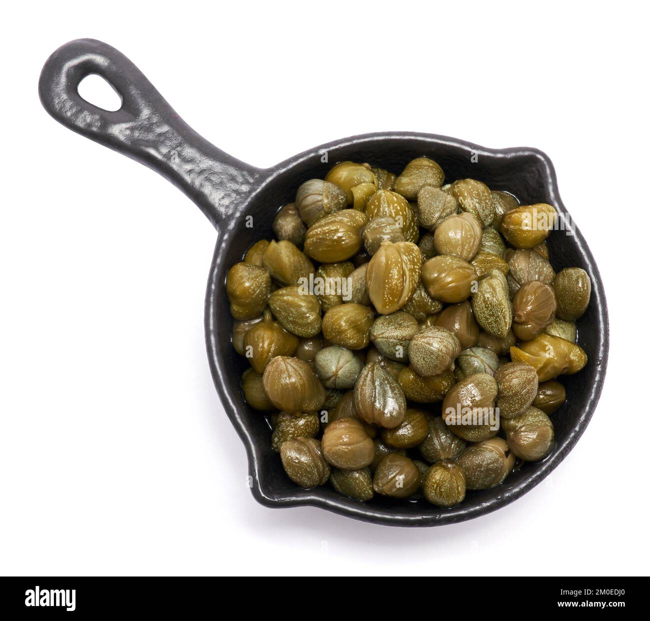 Pickled capers in black ceramic bowl isolated on white background Stock ...