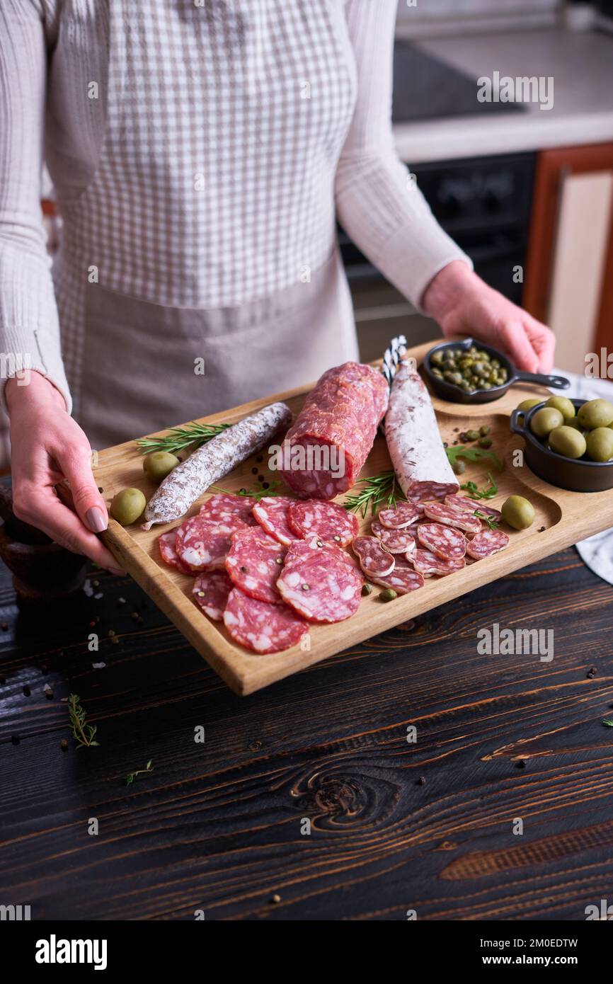Woman cutting smoked sausage hi-res stock photography and images - Alamy