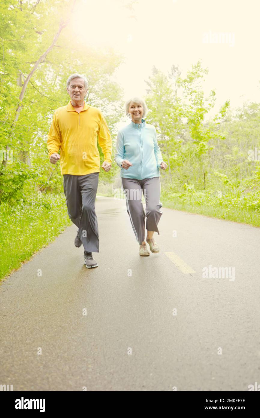 Light jog on a fresh morning. A senior couple going for a brisk jog in ...