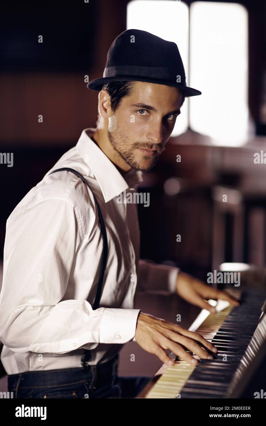 I was born to be a pianist. A handsome young man playing the piano in a ...