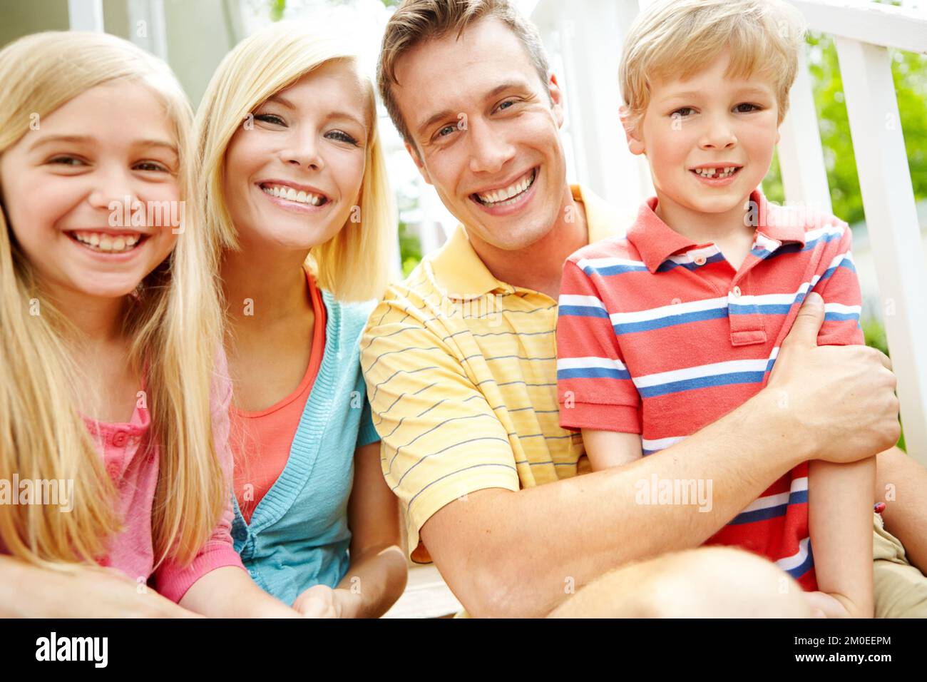 As close as family can be. a young family of four outside Stock Photo ...