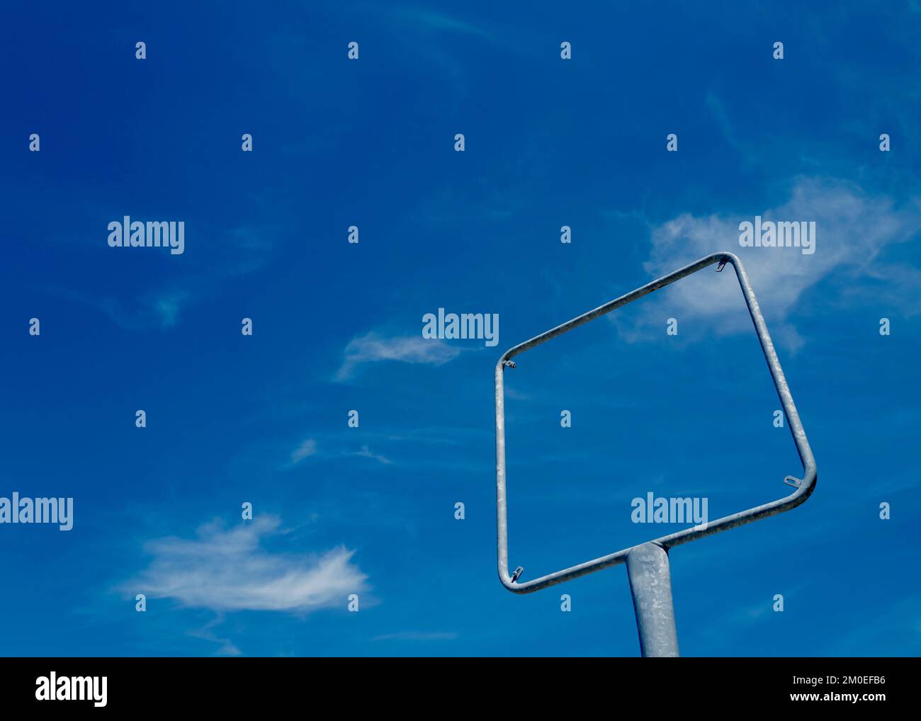 A blank road sign against blue bright sky Stock Photo - Alamy