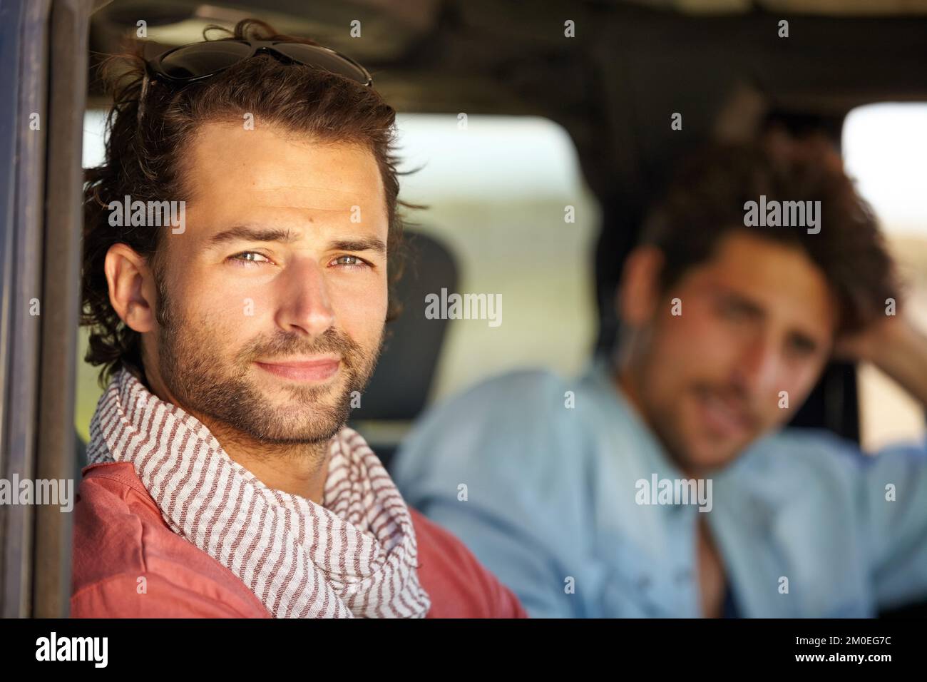 On the road again. Two friends driving together while on a road trip ...