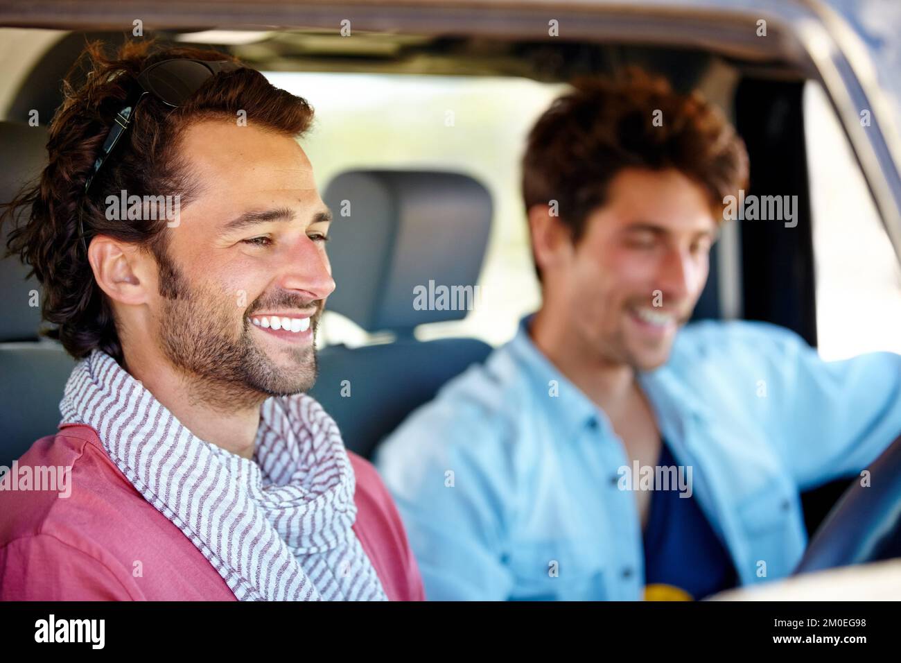 Having a laugh with a friend. Two young male friends sharing a joke ...