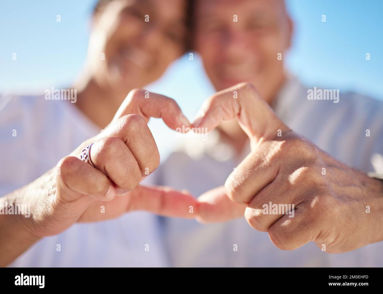 Affectionate mature mixed race couple sharing an intimate moment on the ...