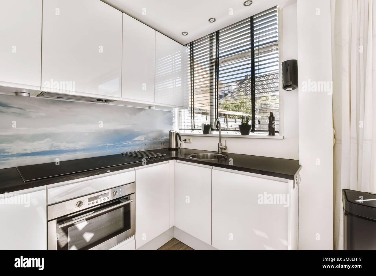 Fragment of interior of light narrow home kitchen with minimalist style ...