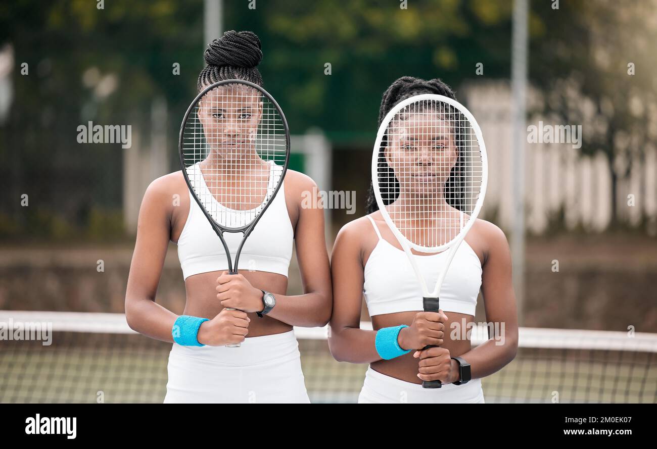 Serious tennis players holding their rackets. Portrait of young tennis ...