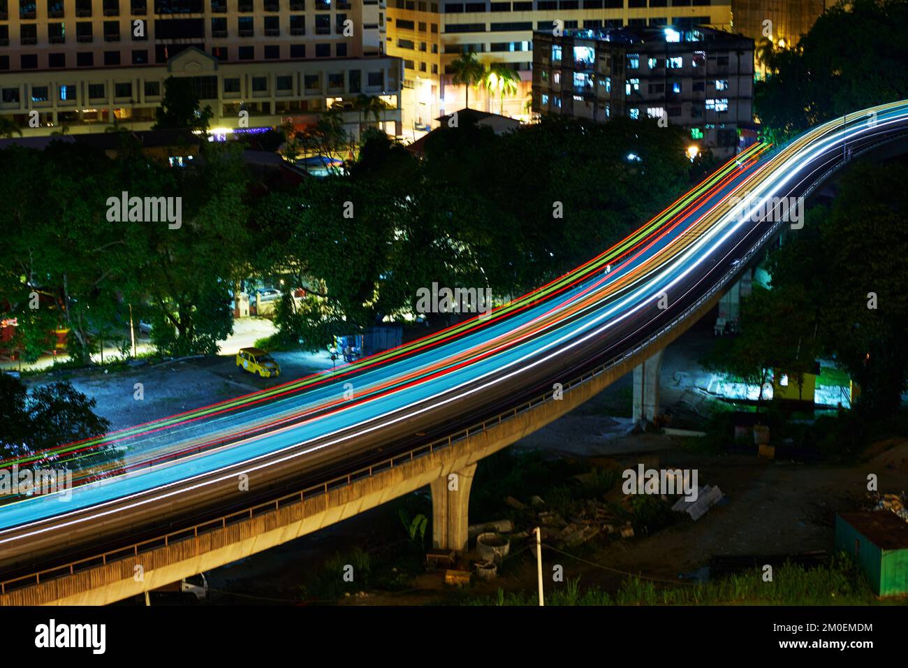 Light rail transit train moving through the city in the night Stock ...