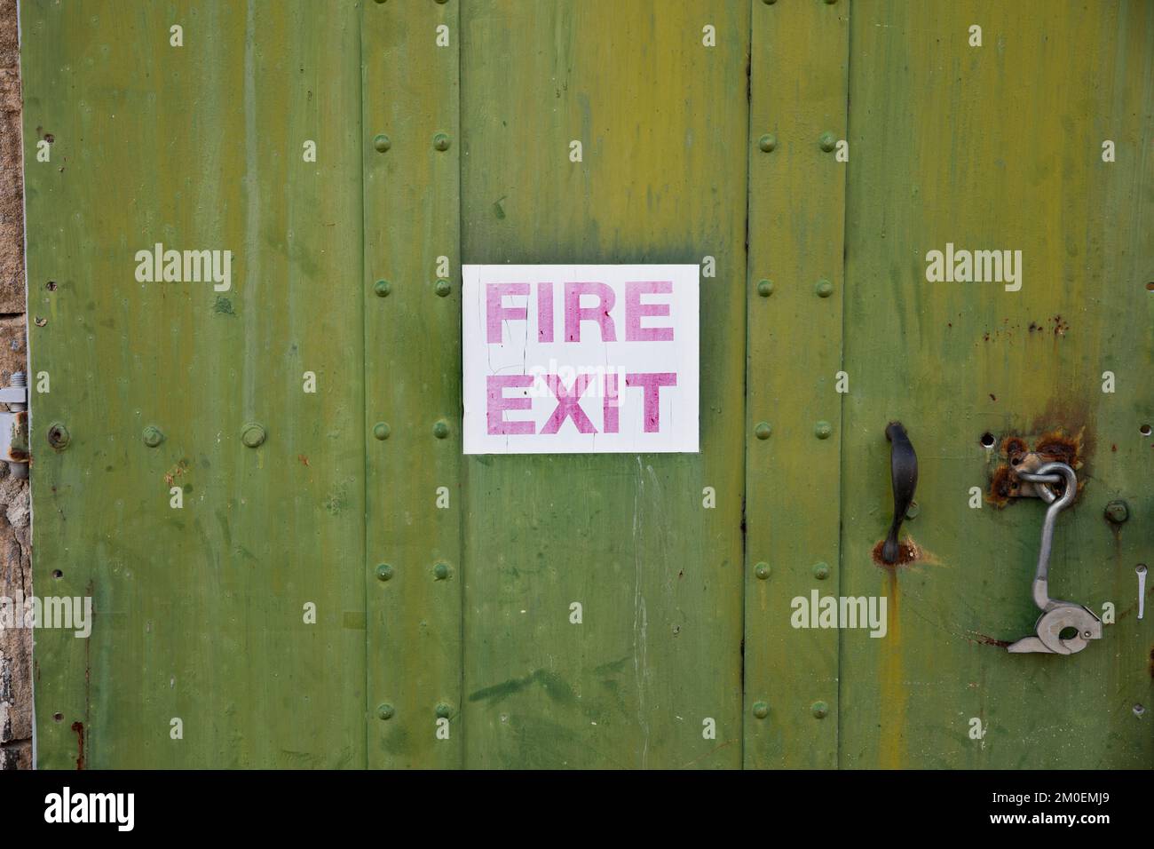 old faded fire exit sign Stock Photo - Alamy