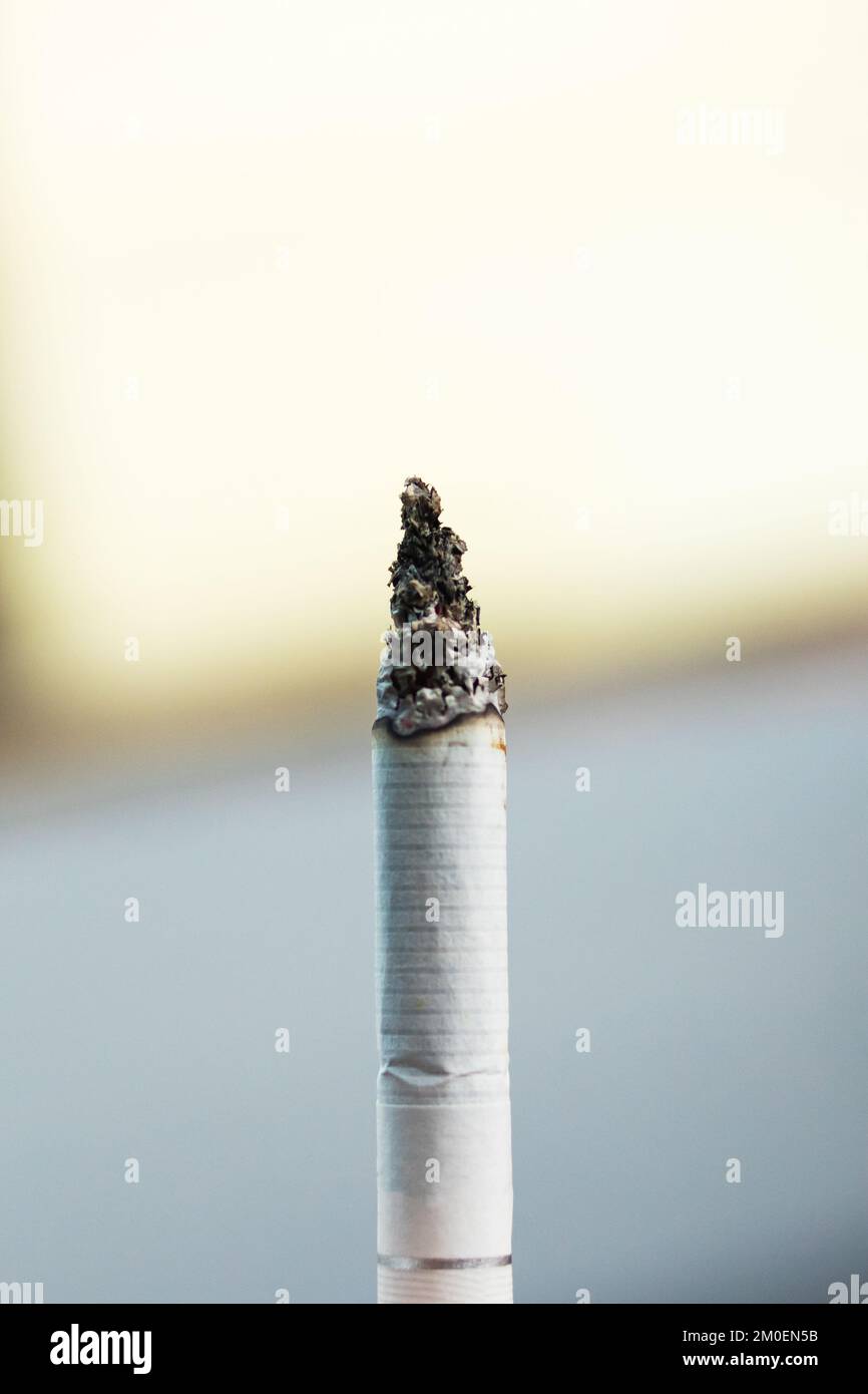 Hand smoking lit cigarette hi-res stock photography and images - Alamy