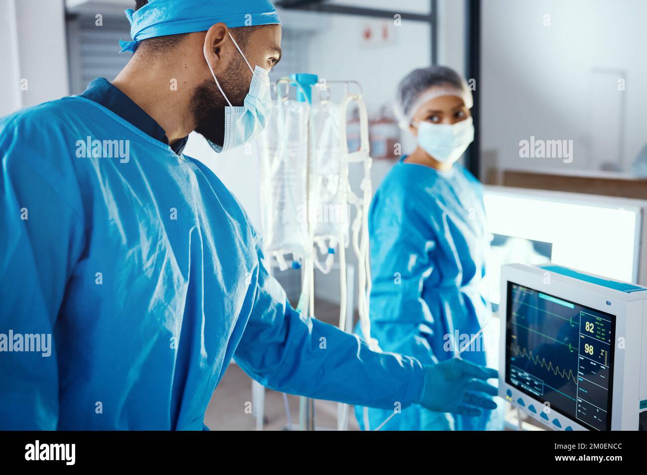 Surgery, team and checking machine while preparing for medical ...