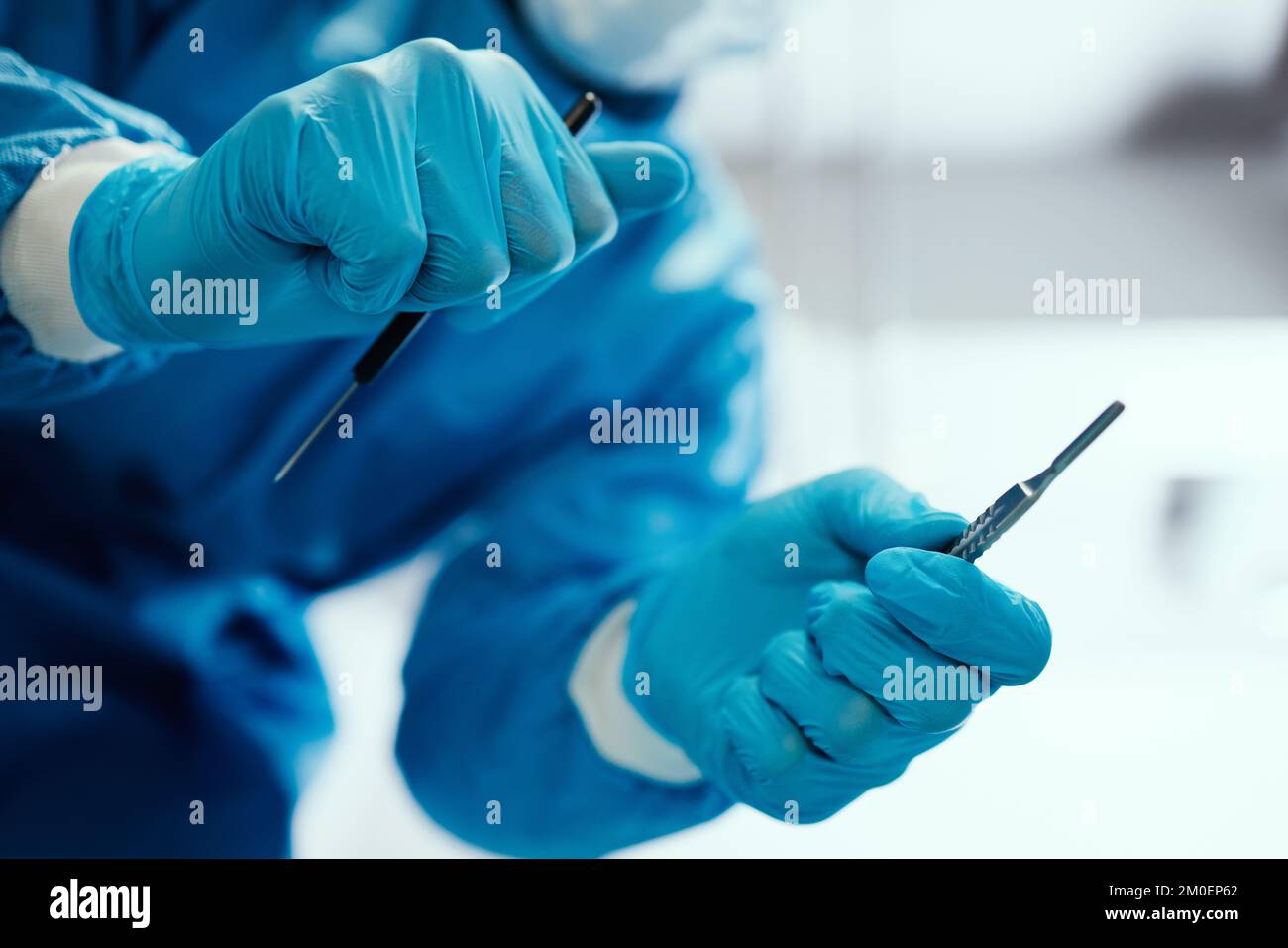 Healthcare, surgeon and hands with a scalpel for procedure in an ...