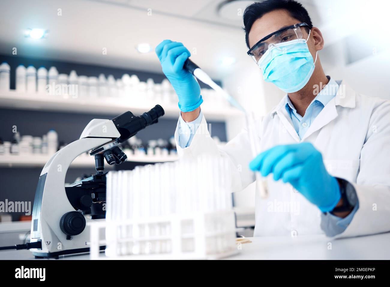 Covid, microscope and experiment with a man scientist working on ...