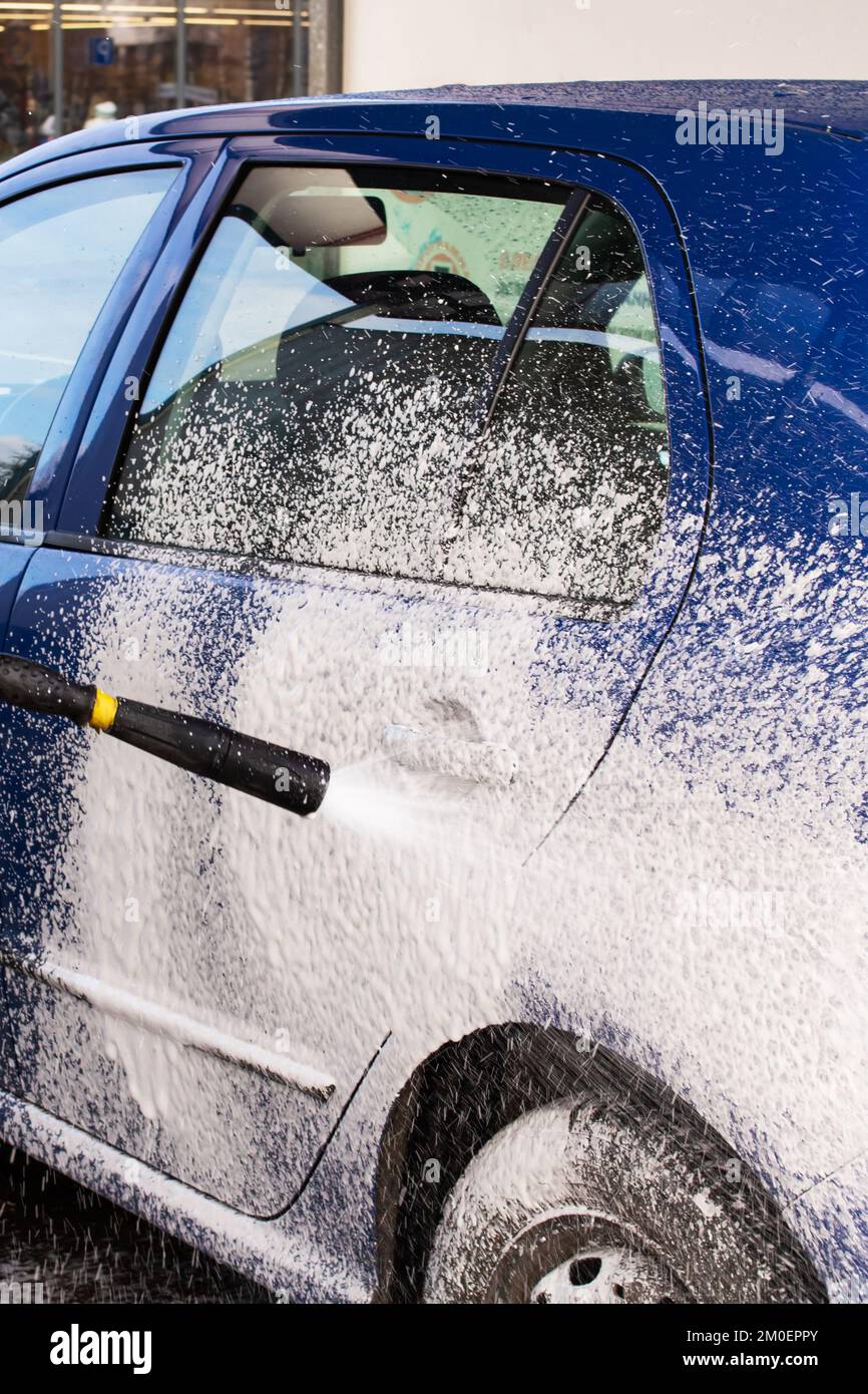 Blue car in foam at a car wash close up Stock Photo - Alamy